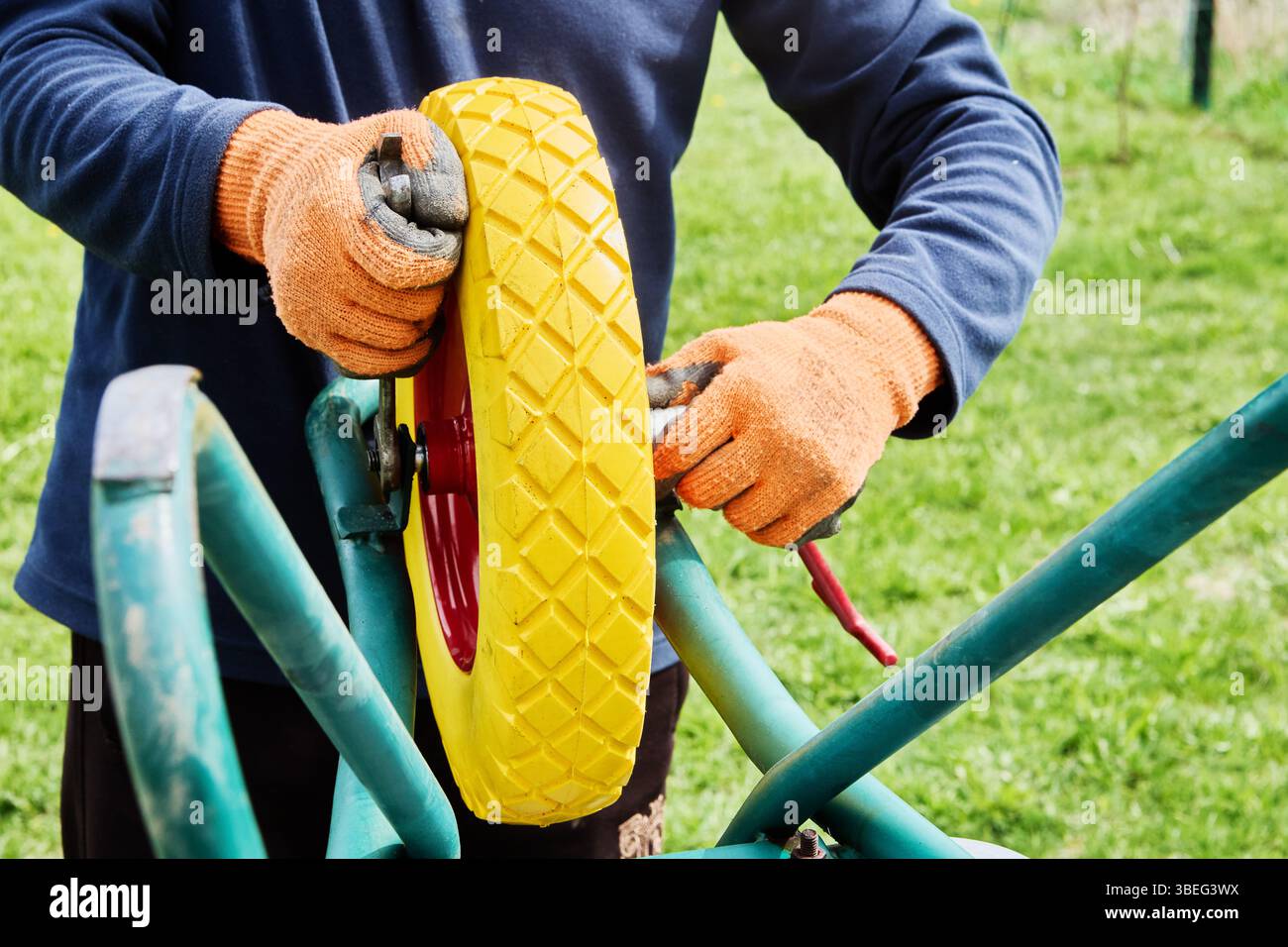 Gardener farmer changing fixing wheelbarrow hi-res stock photography ...