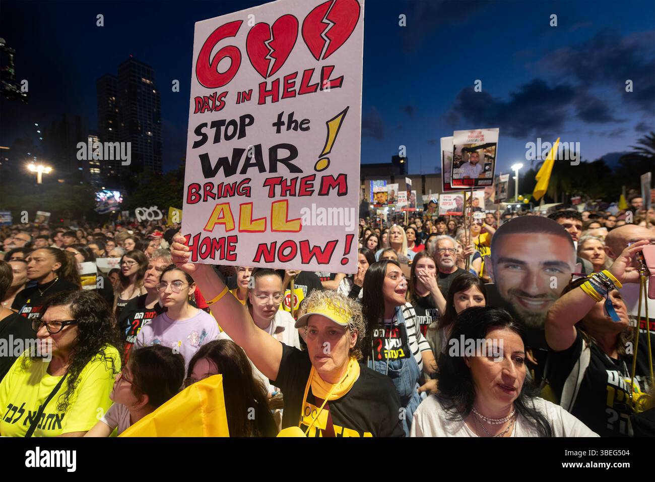 A protester holds a placard reading "600 days in hell, stop war ...