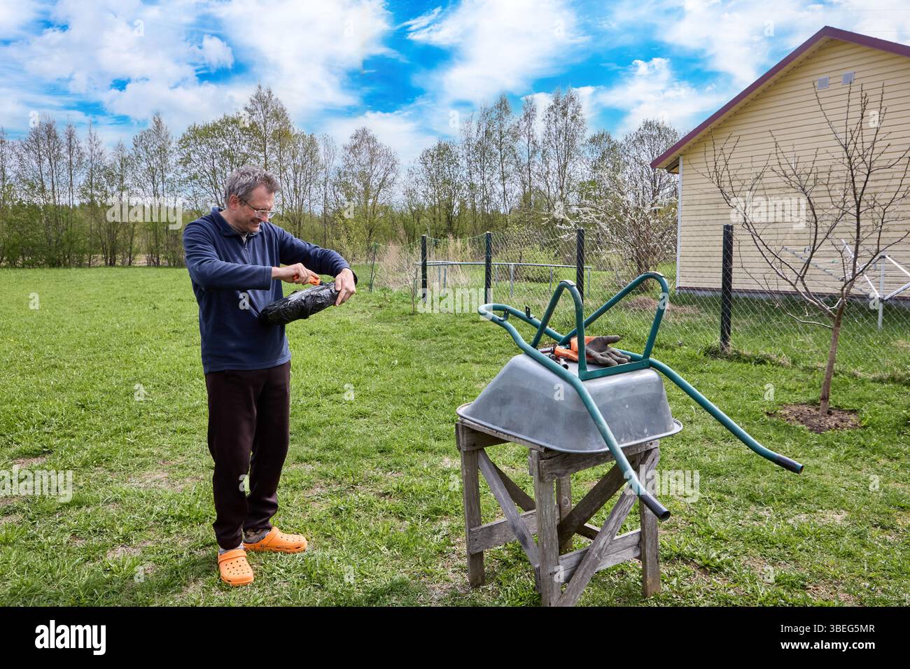 Gardener farmer fixing new wheelbarrow hi-res stock photography and ...