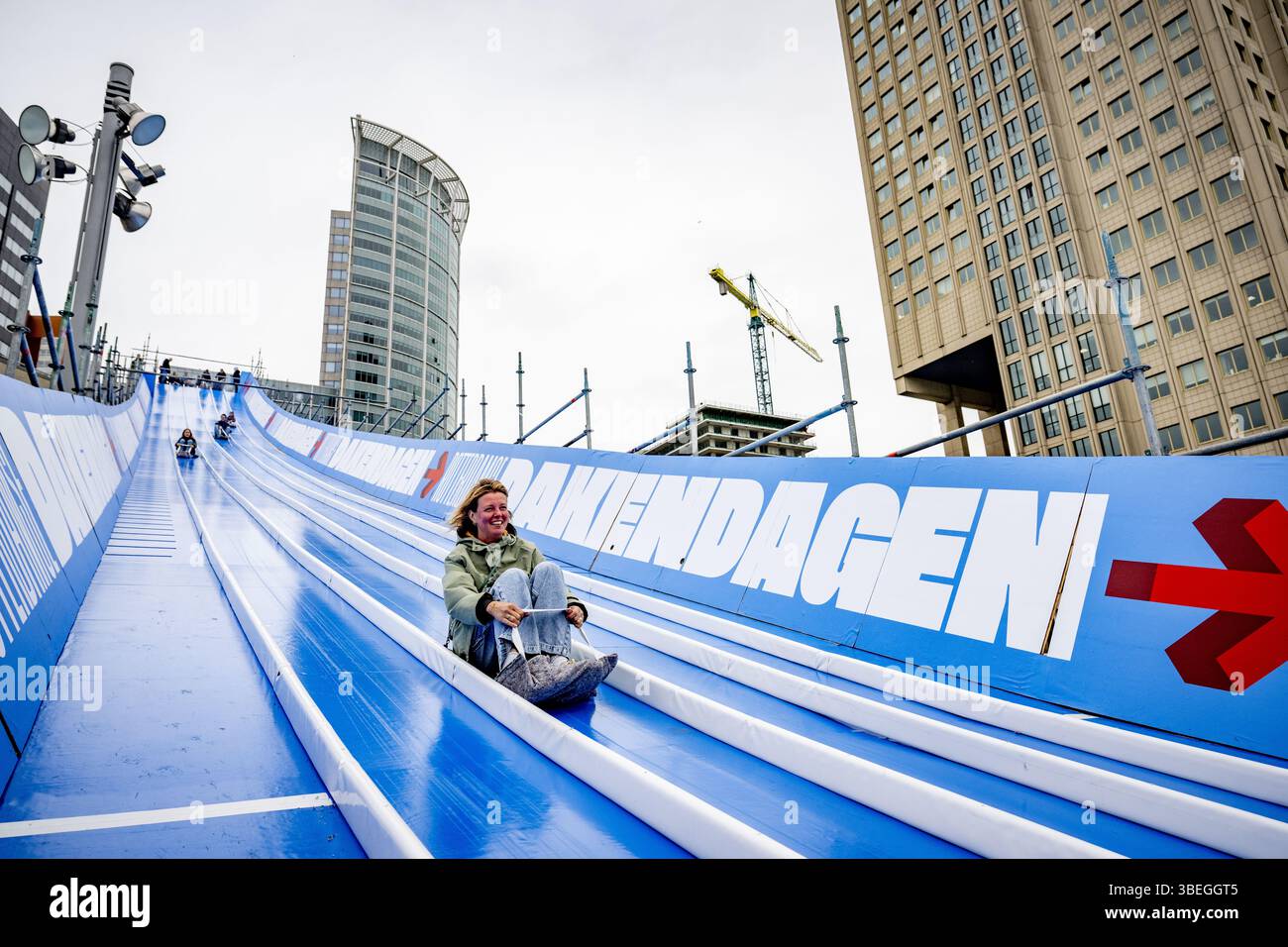 ROTTERDAM - Visitors use the Rotterdam Rooftop Roller Coaster during ...