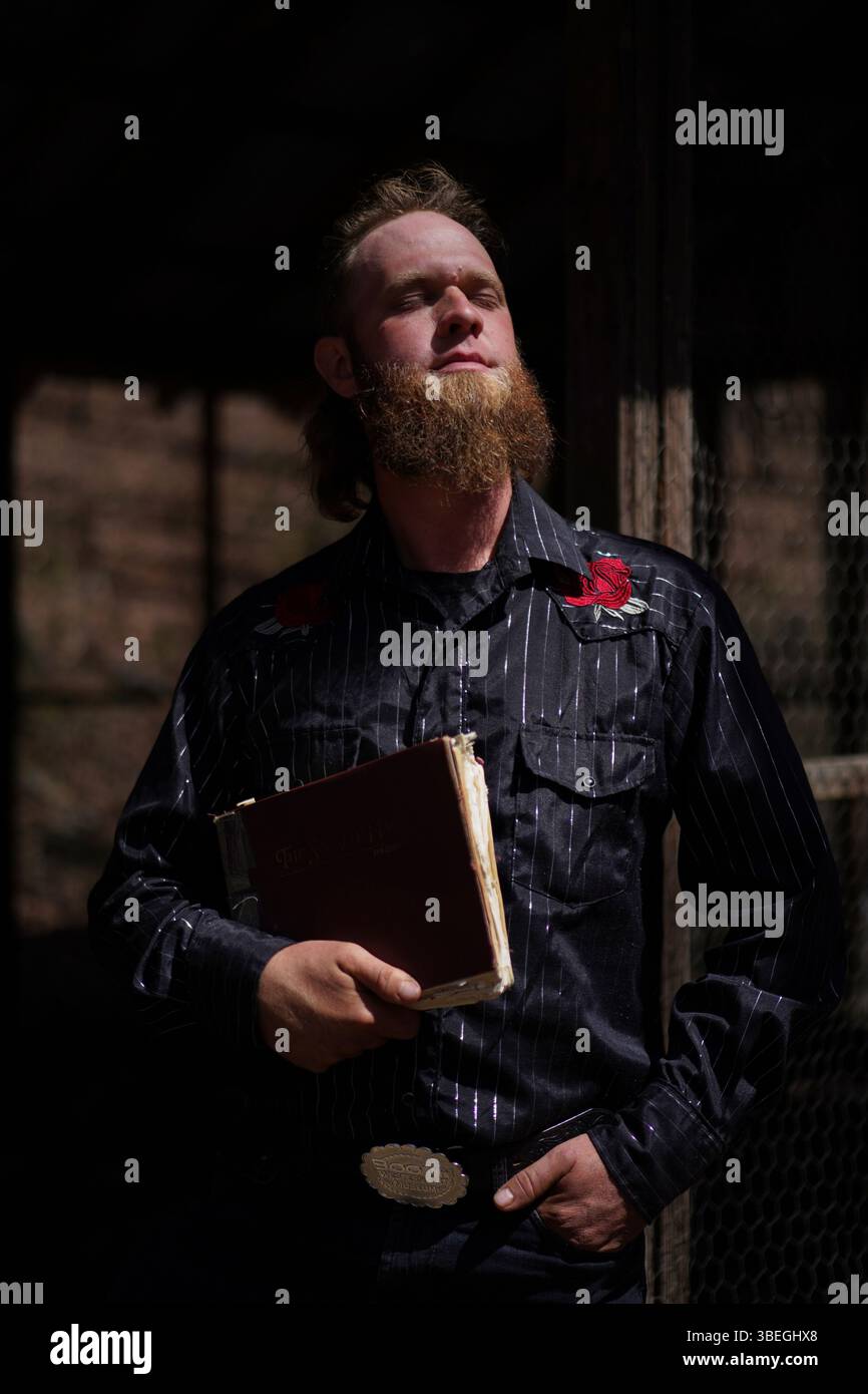 Isaac Green, 34, poses for a portrait with his copy of "The Sacred Harp ...
