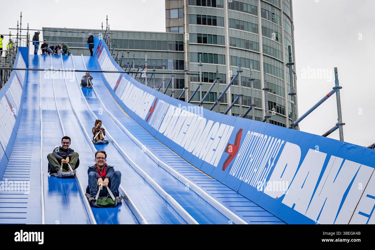 ROTTERDAM - Visitors use the Rotterdam Rooftop Roller Coaster during ...