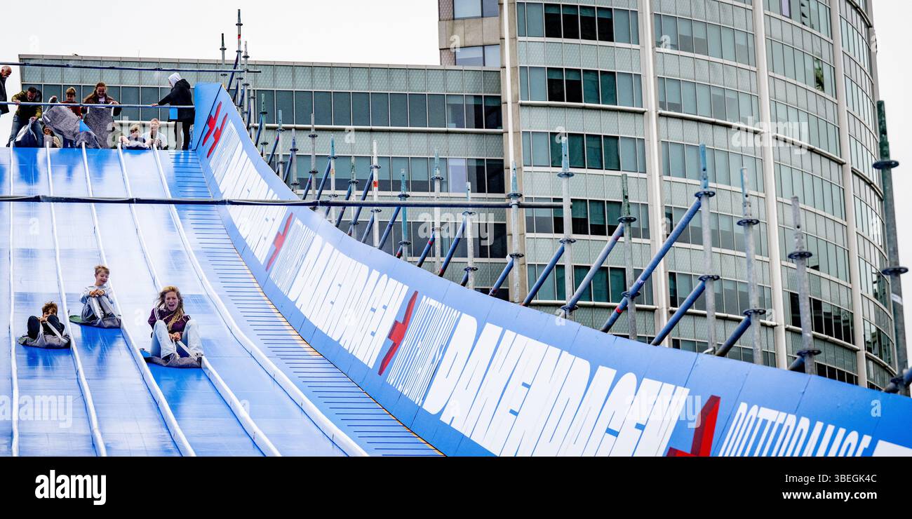 ROTTERDAM - Visitors use the Rotterdam Rooftop Roller Coaster during ...
