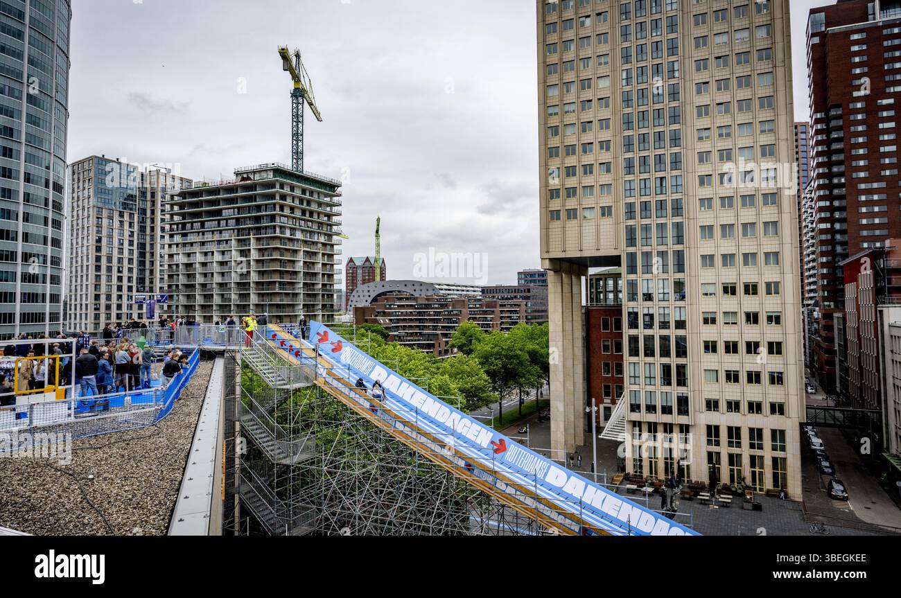 ROTTERDAM - Visitors use the Rotterdam Rooftop Roller Coaster during ...