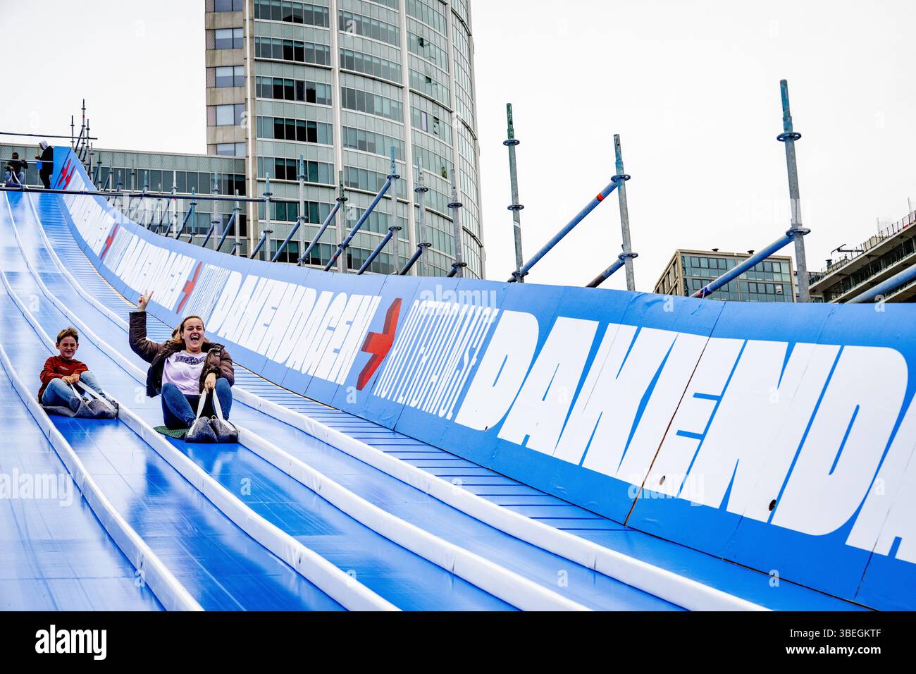 ROTTERDAM - Visitors use the Rotterdam Rooftop Roller Coaster during ...