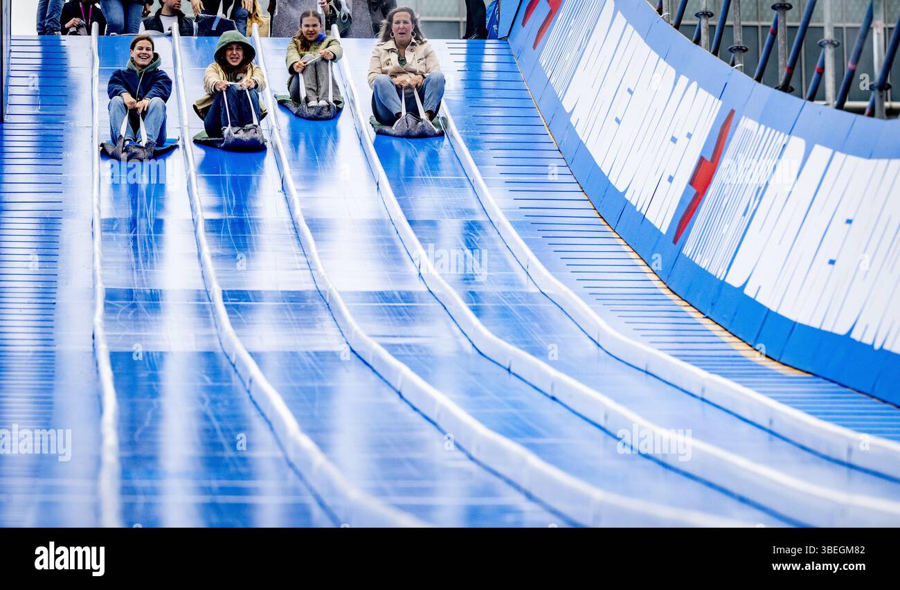 ROTTERDAM - Visitors use the Rotterdam Rooftop Roller Coaster during ...