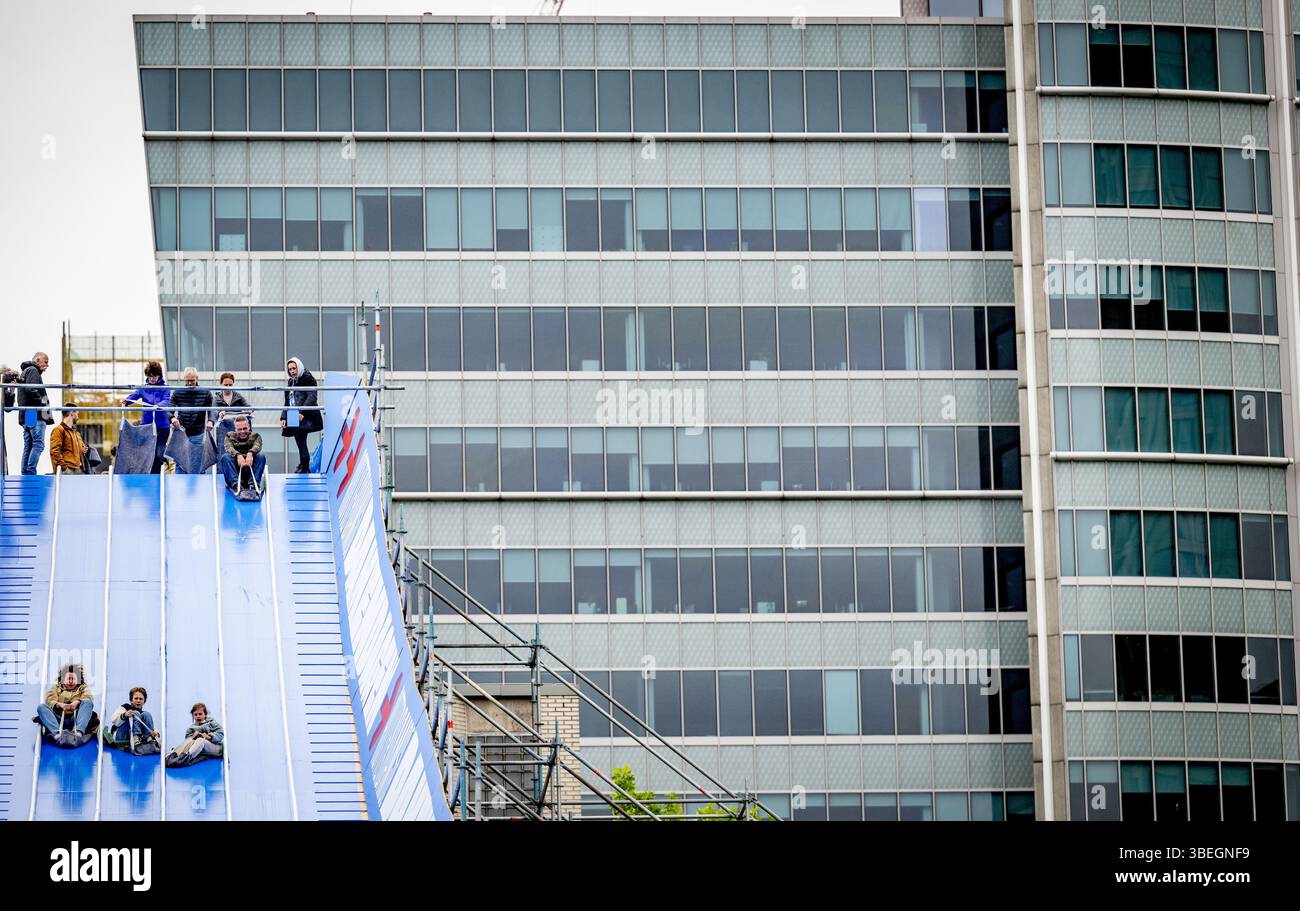 ROTTERDAM - Visitors use the Rotterdam Rooftop Roller Coaster during ...