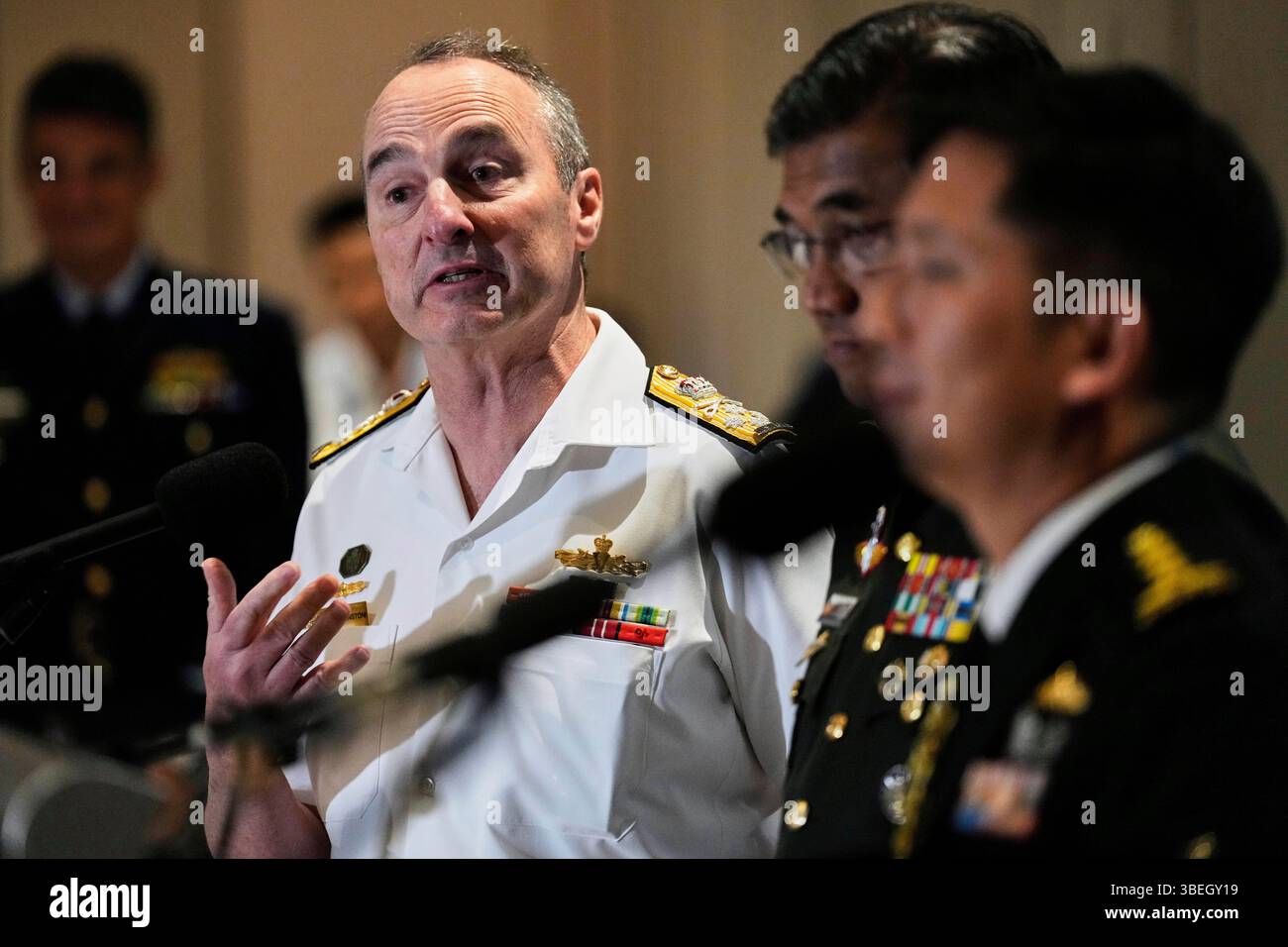 Australia's Chief of Defence Force Admiral David Johnston, left, speaks ...