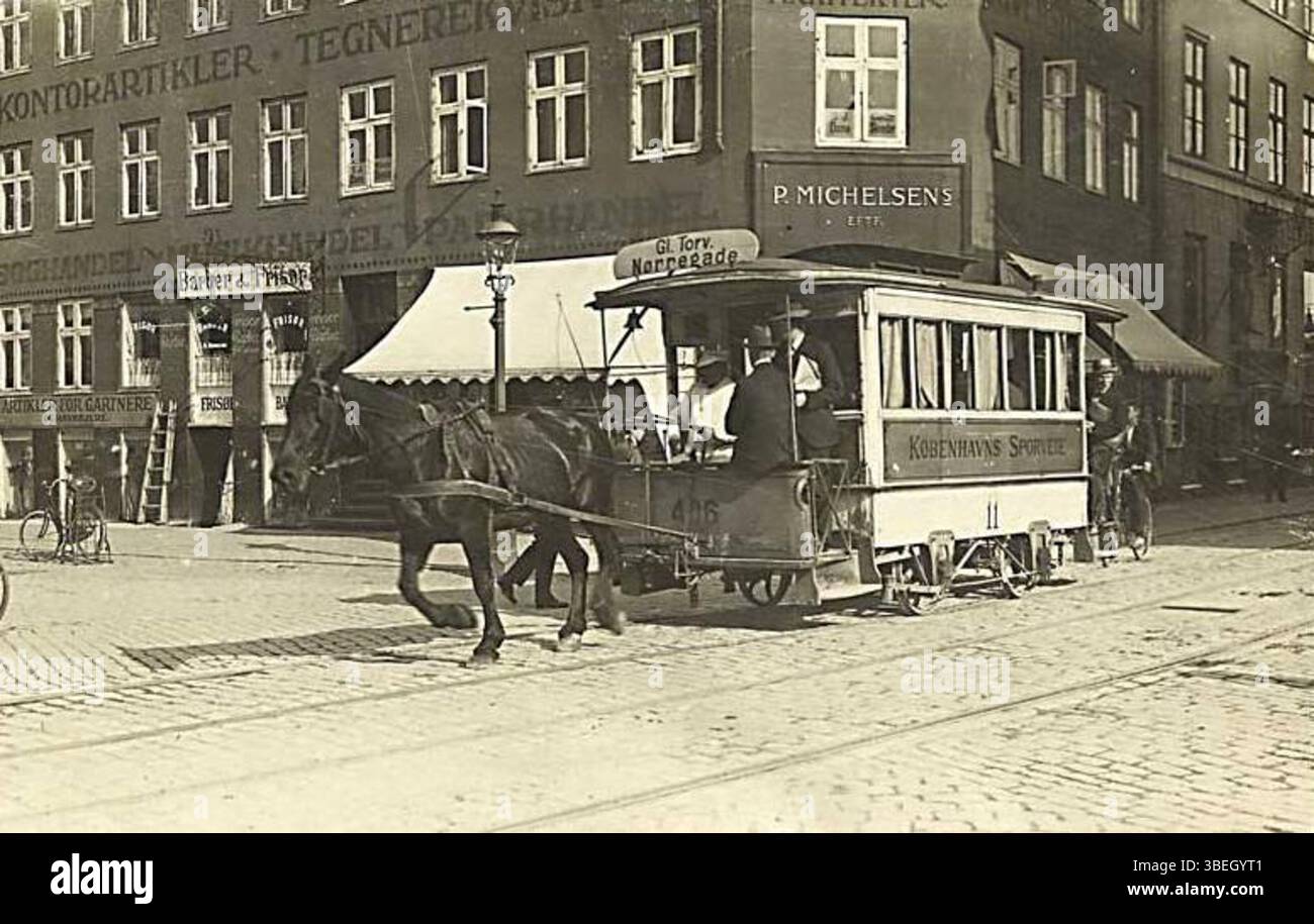 This photograph depicts a tram passing in front of Nørregade 6 in ...