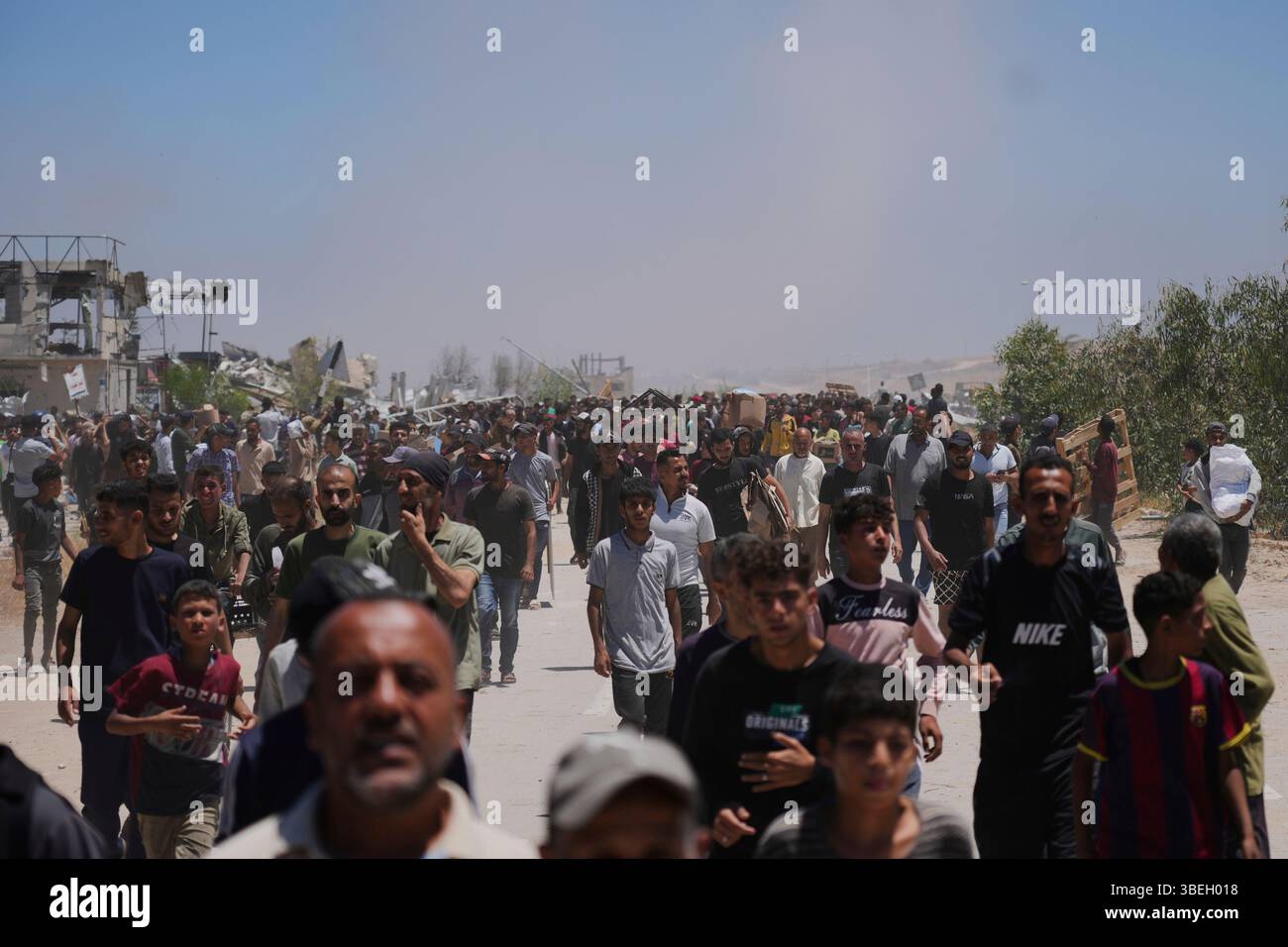 Palestinians carry boxes and bags containing food and humanitarian aid ...