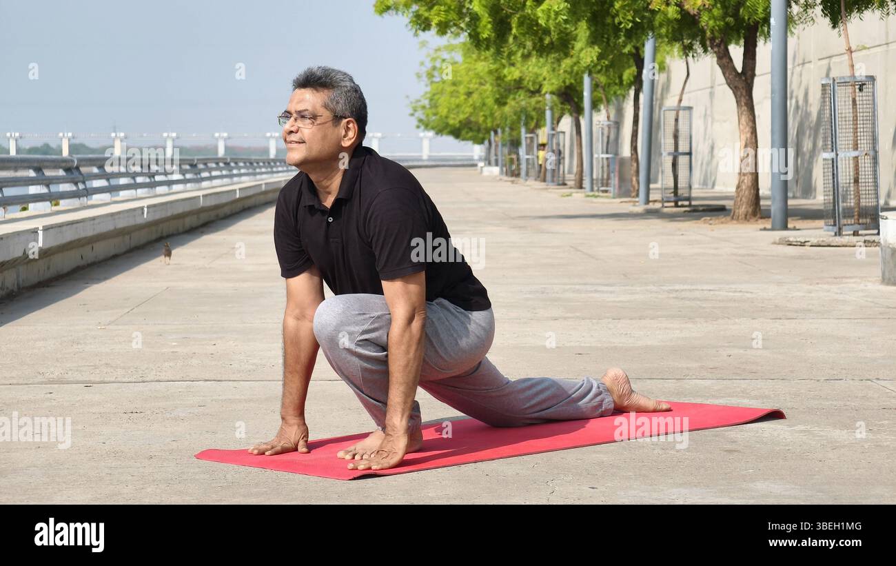 Senior Indian Man performing Ashwa Sanchalanasana (Equestrian Pose ...