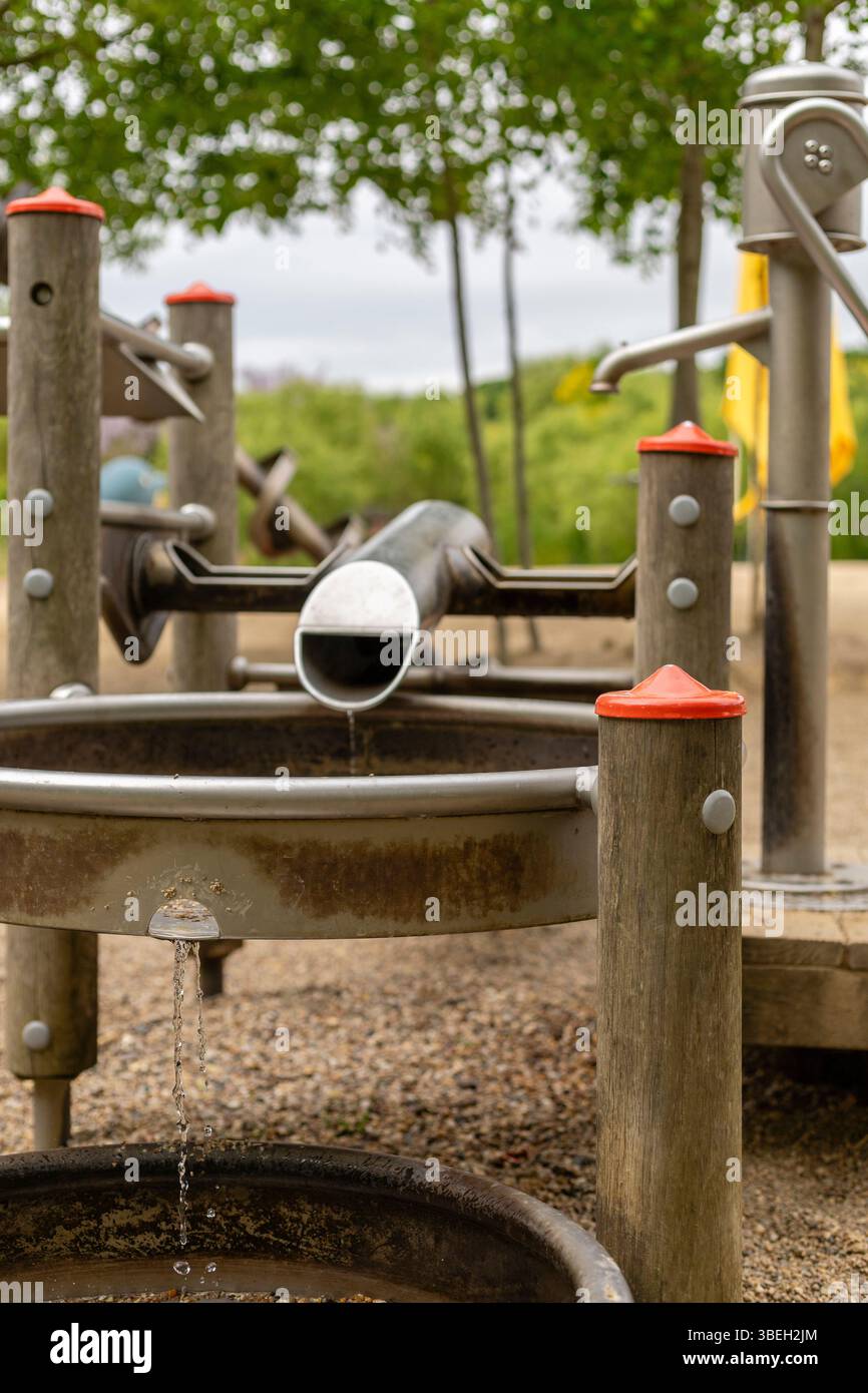 Children enjoy a water play area equipped with various interactive ...