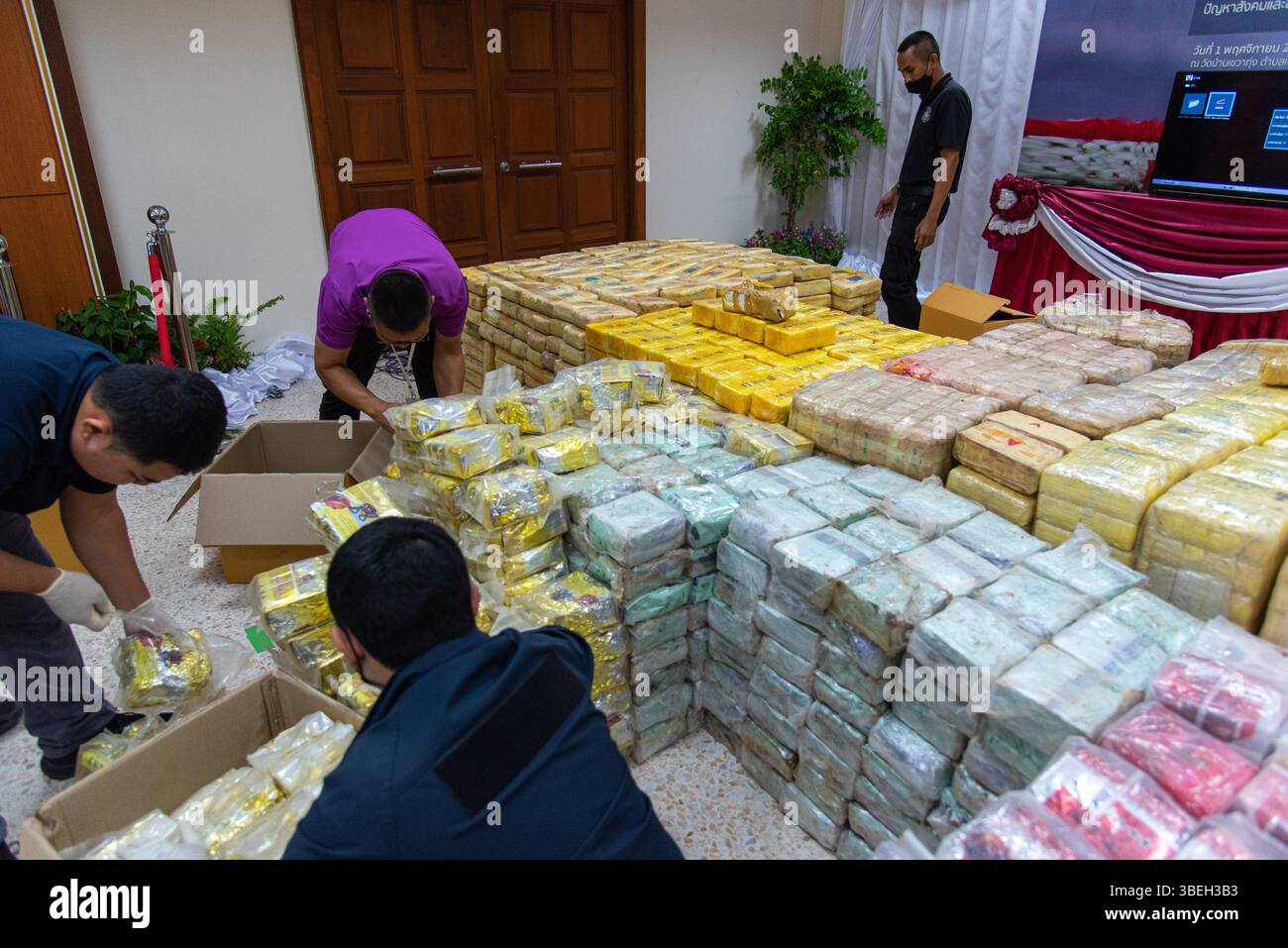 Thai Narcotics Suppression police officers seen collect the pile of the ...