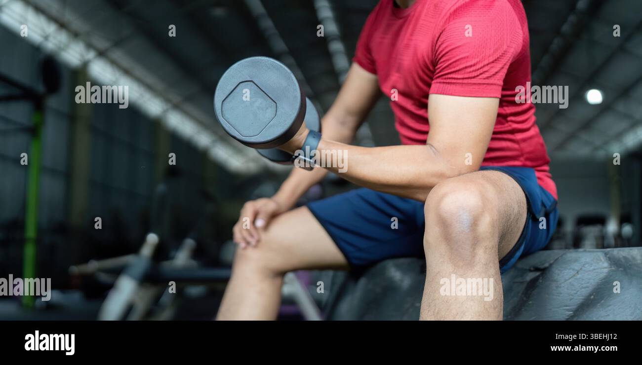 Wellness through Strength. Man lifting a dumbbell while seated ...