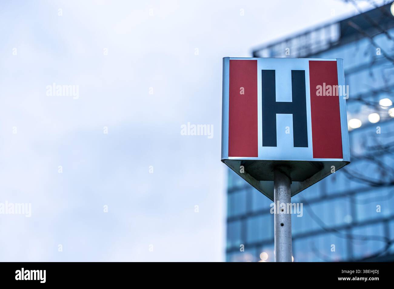 Red fire hydrant sign against office building and sky background Stock ...
