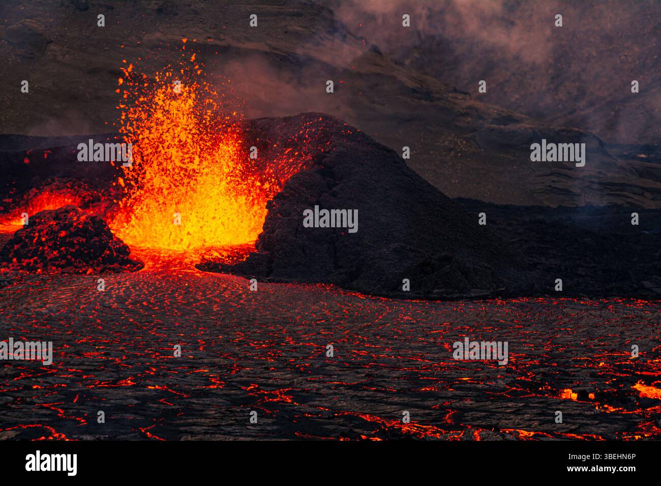 Volcanic eruption with lava flow and fiery explosion in a rugged landscape, raw power of nature ...