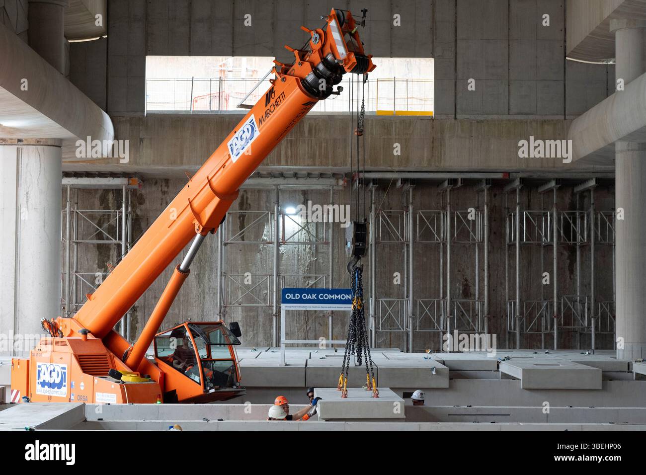 Construction workers lower a precast platform slab during the ...