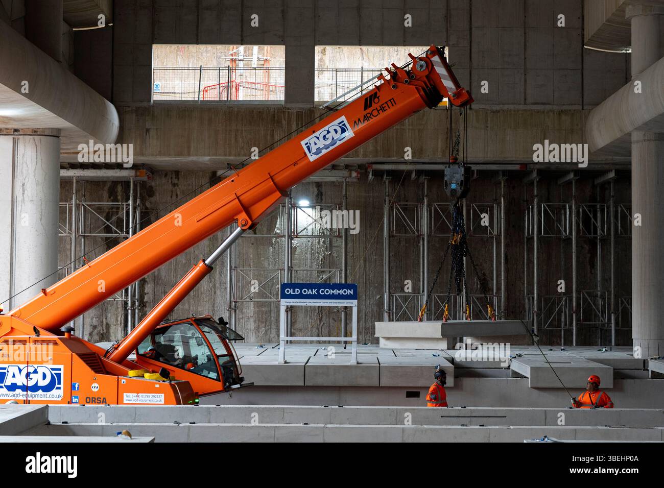 Construction workers lower a precast platform slab during the ...