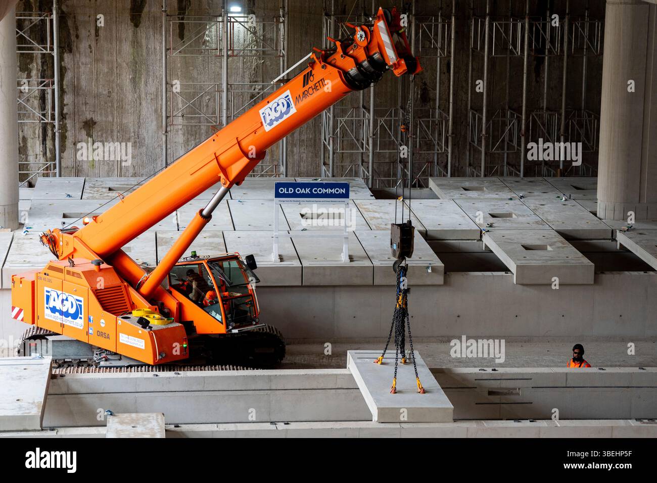 Construction workers lower a precast platform slab during the ...