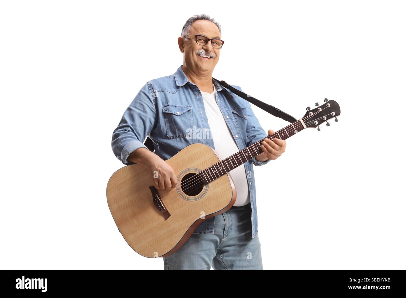 Mature man standing and playing an acoustic guitar isolated on white ...