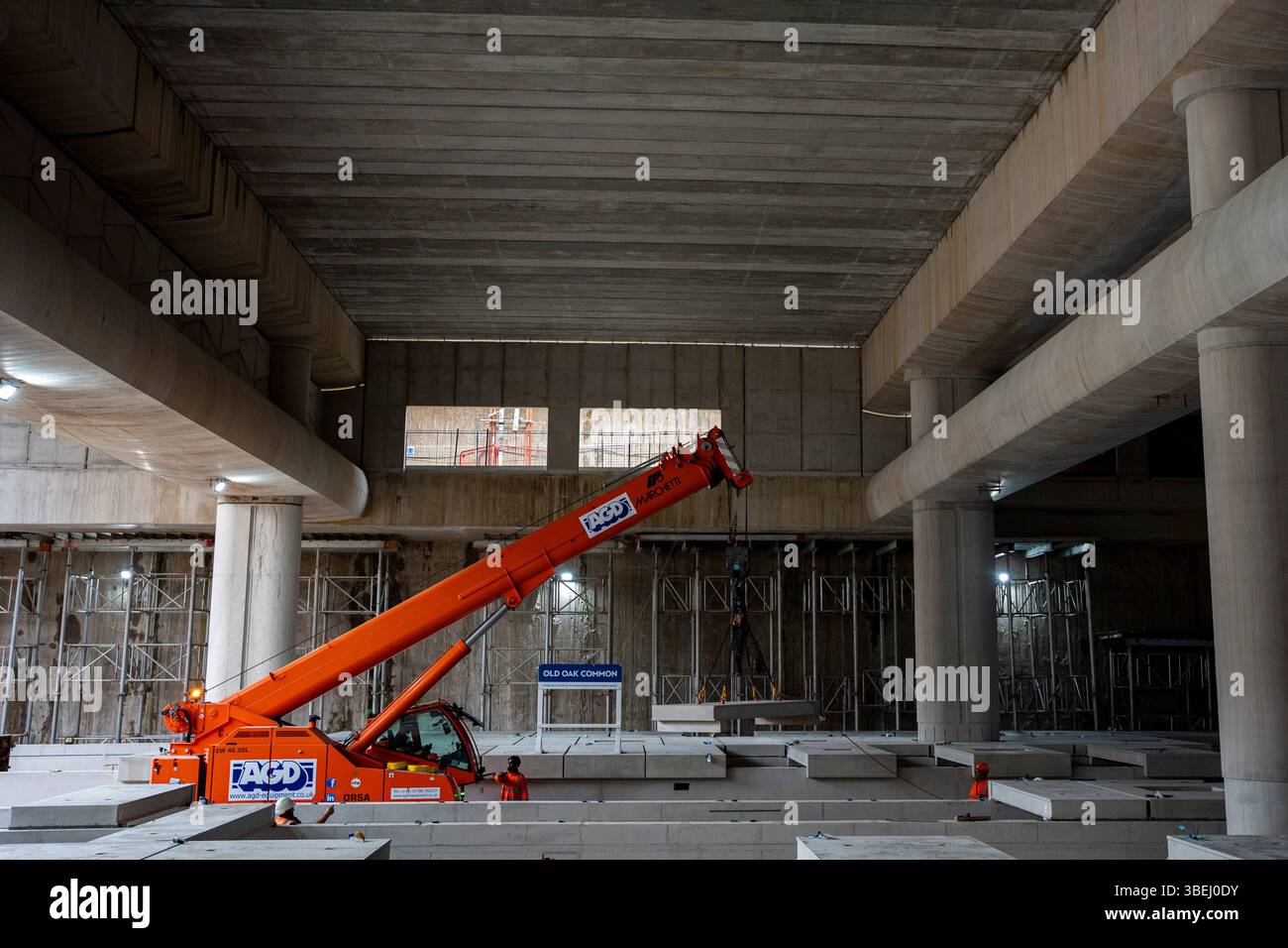 Construction workers lower a precast platform slab during the ...
