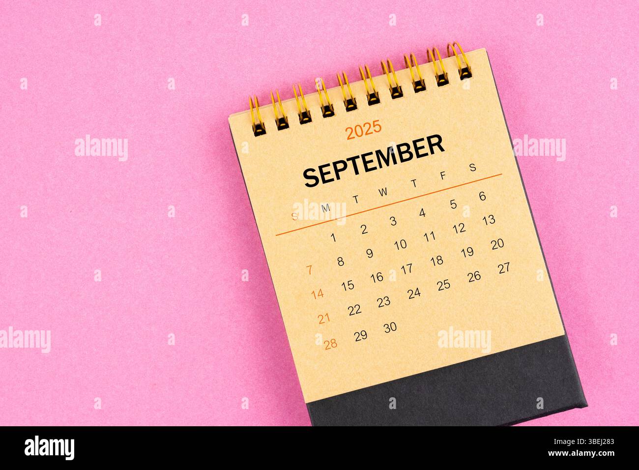 Brown desk calendar for September 2025 on pink color background Stock ...