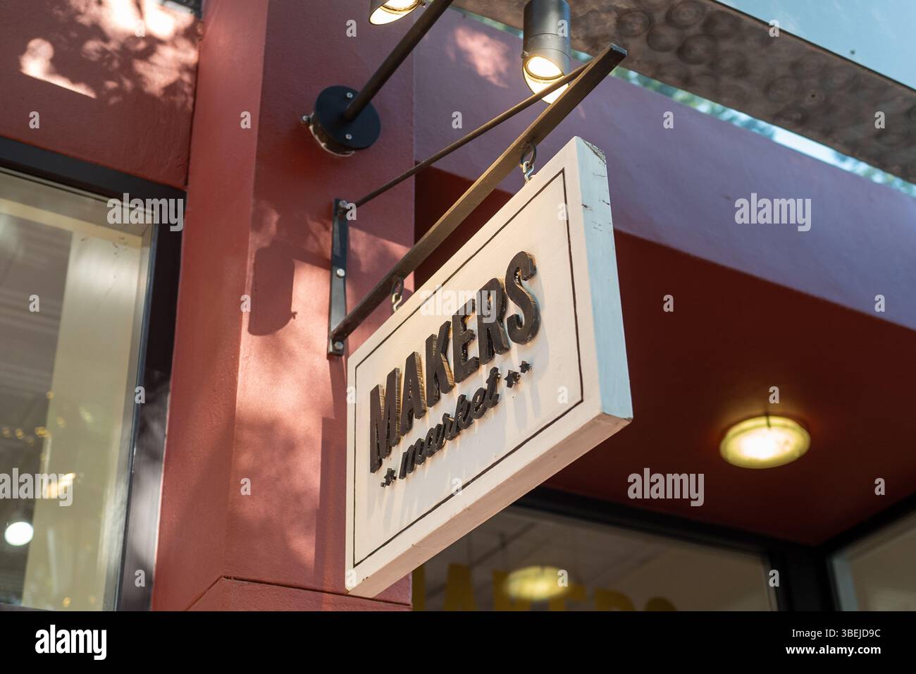 Wooden signboard for Makers Market shop, illuminated by light fixtures ...