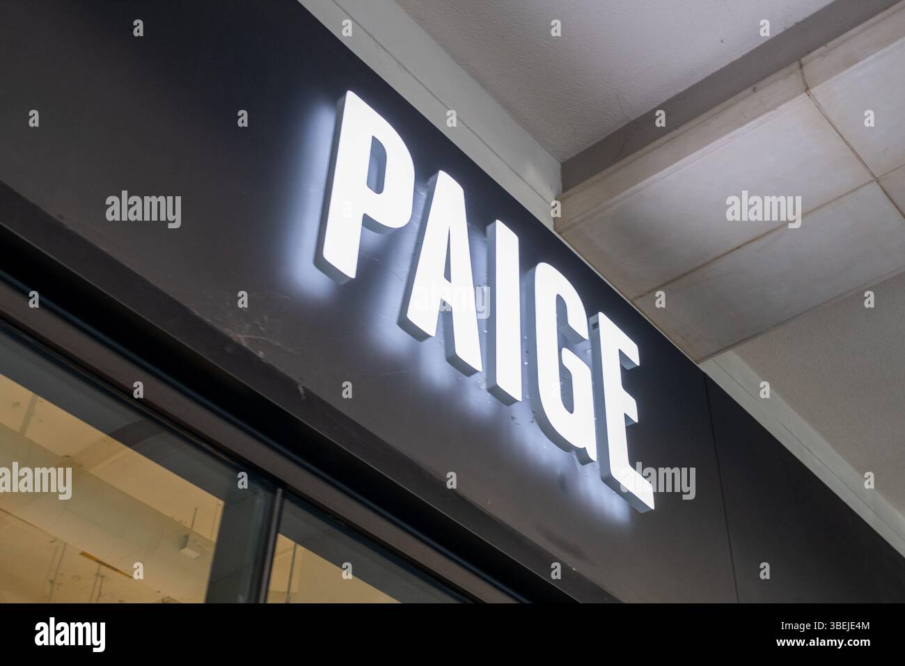 Close-up of illuminated PAIGE store sign at Santana Row, San Jose ...