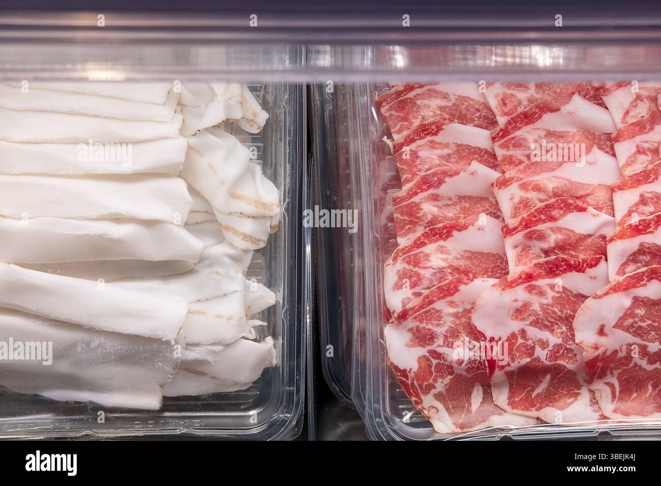 Traditional Italian cured pork products displayed in a supermarket deli ...
