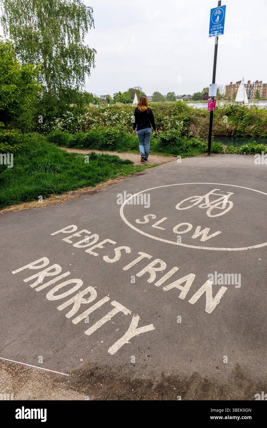Slow cyclists pedestrian priority sign painted on path, Hackney, London ...