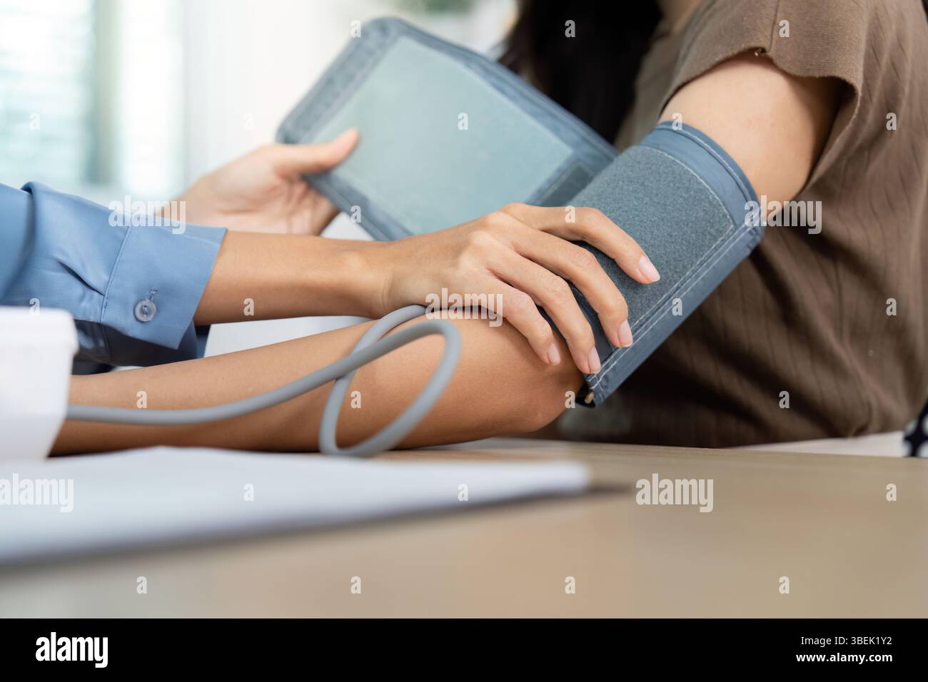 Nurse Conducting Blood Pressure Measurement. Professional nurse taking ...