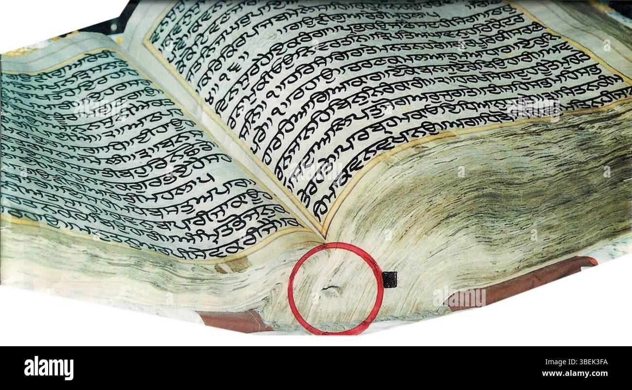 Handwritten manuscript of the Guru Granth Sahib, damaged by a bullet ...
