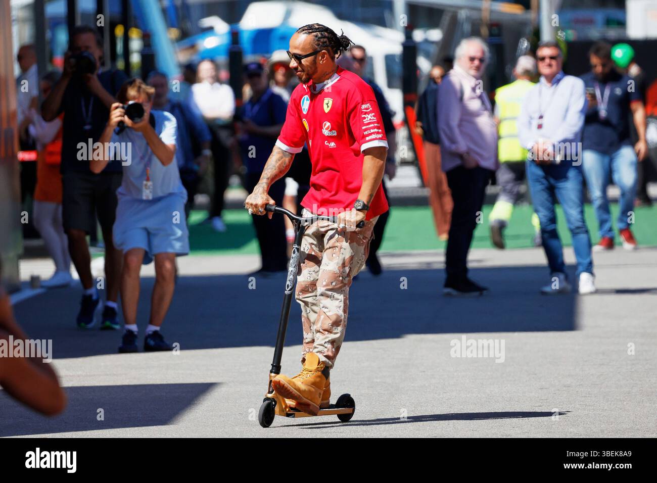 Lewis Hamilton, of United Kingdom, rides a scooter at the Barcelona ...