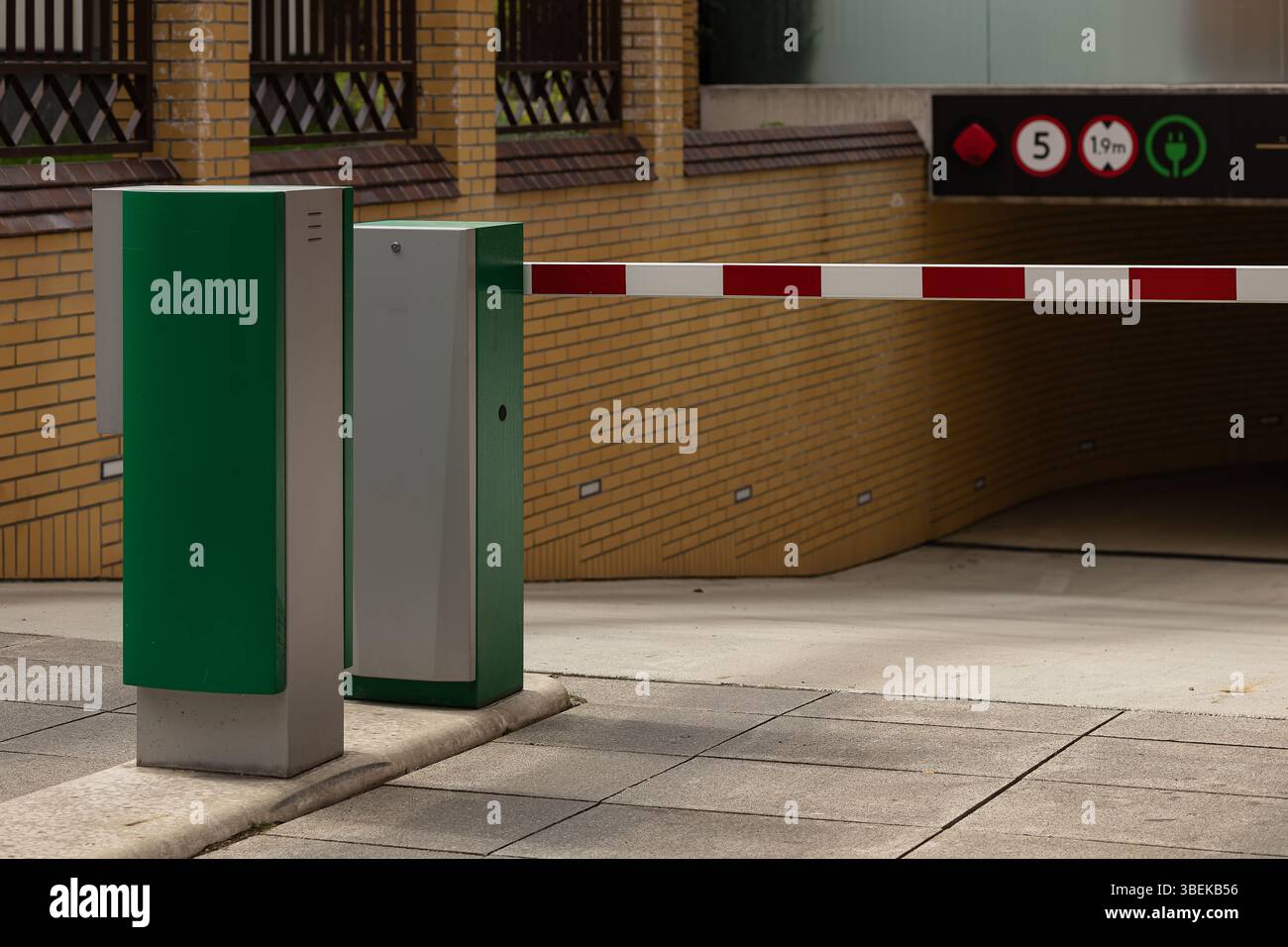Automatic entry barrier at modern underground parking garage with ...