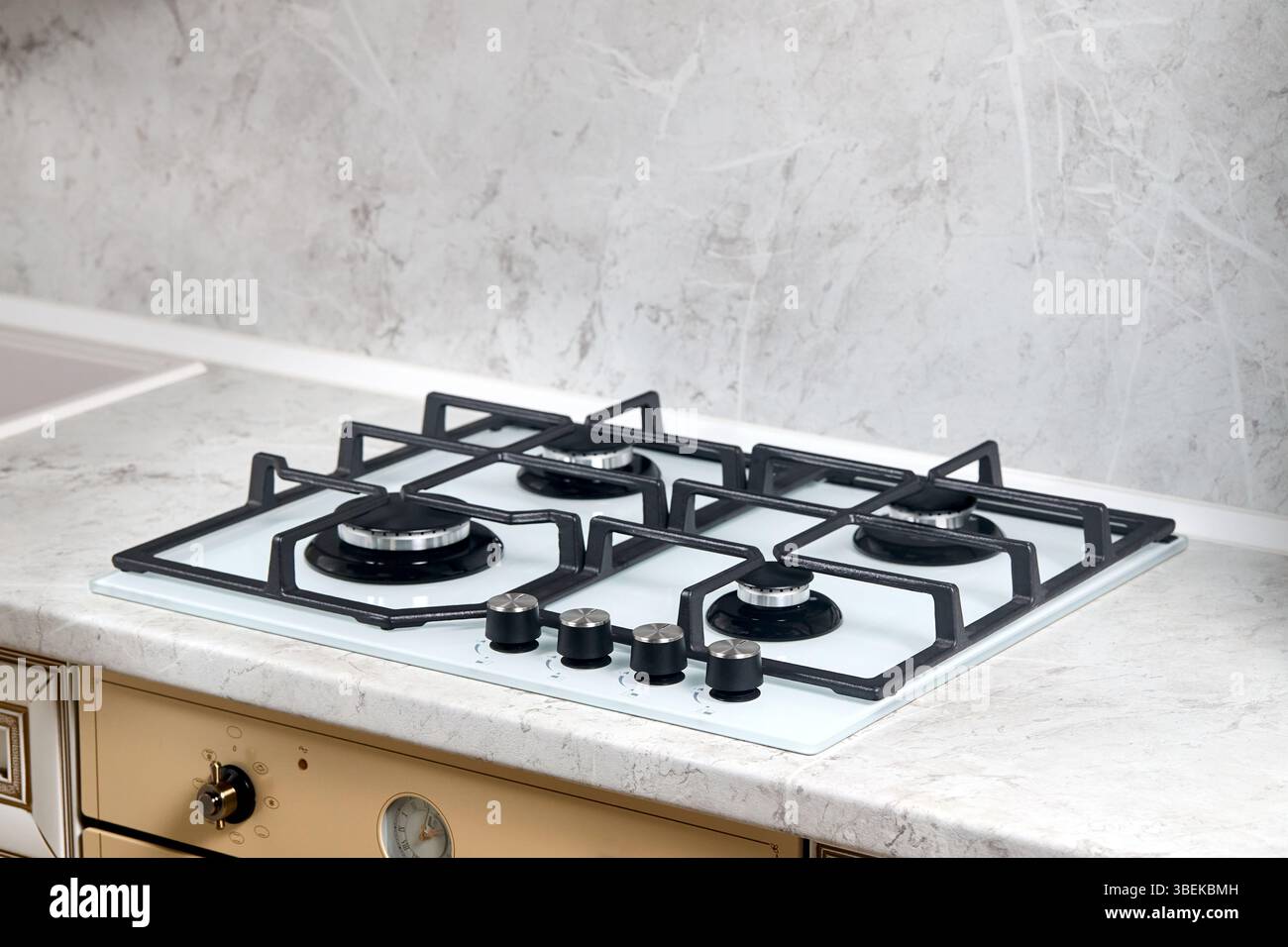Modern white gas stove on counter top closeup. Hob gas stove made of ...