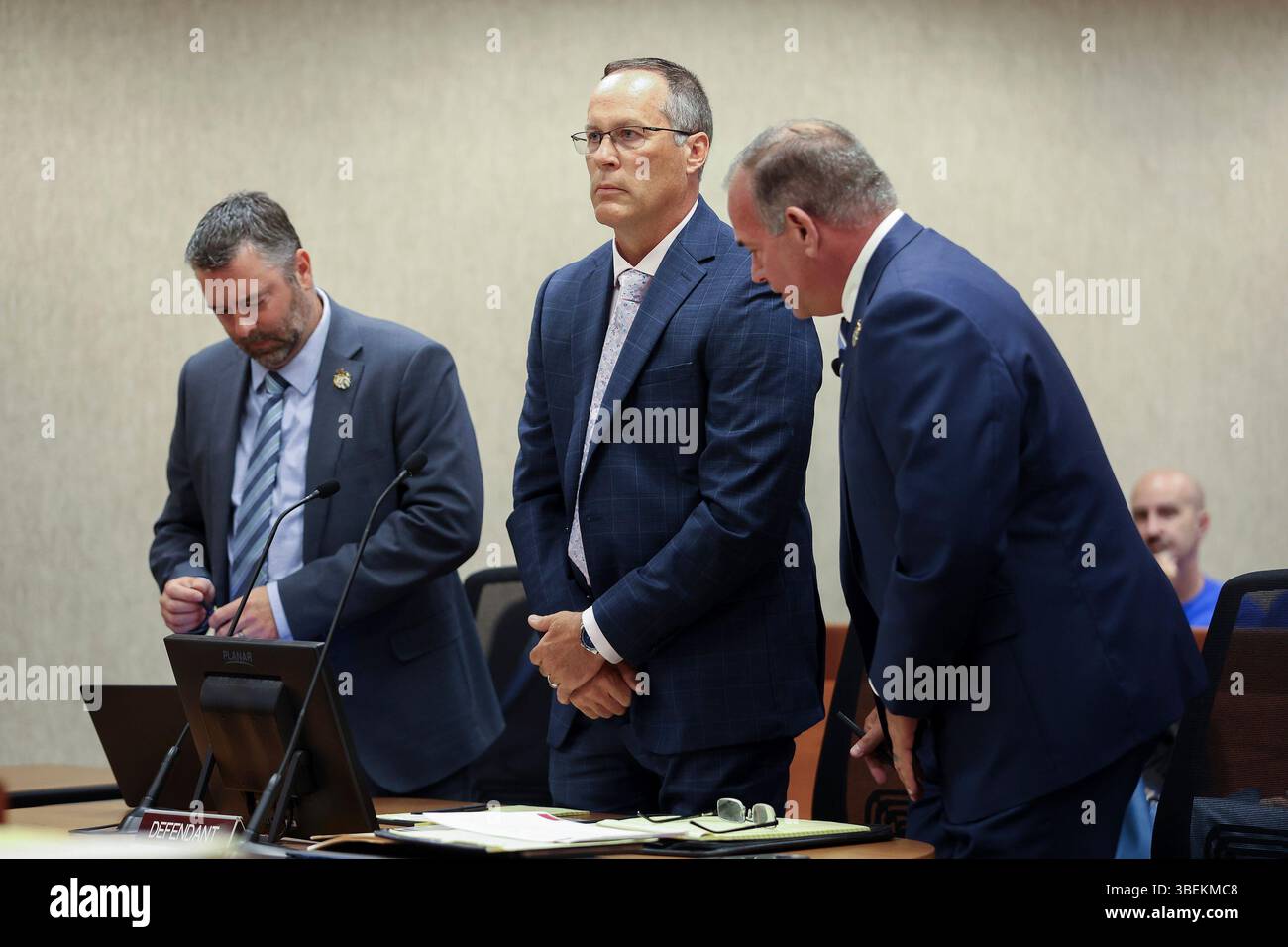 Former Michigan State Police trooper Brian Keely, center, appears in ...