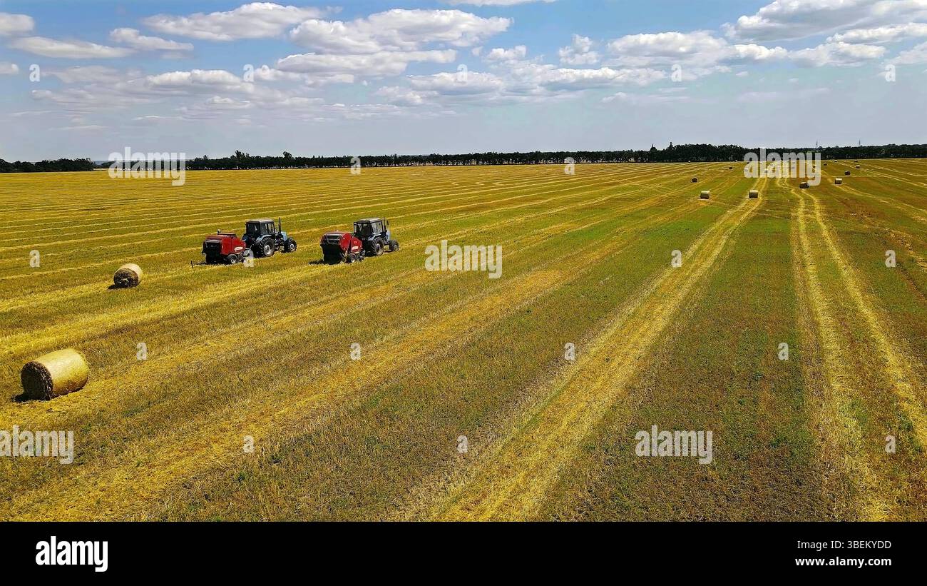 Two tractors harvesting hay hi-res stock photography and images - Alamy