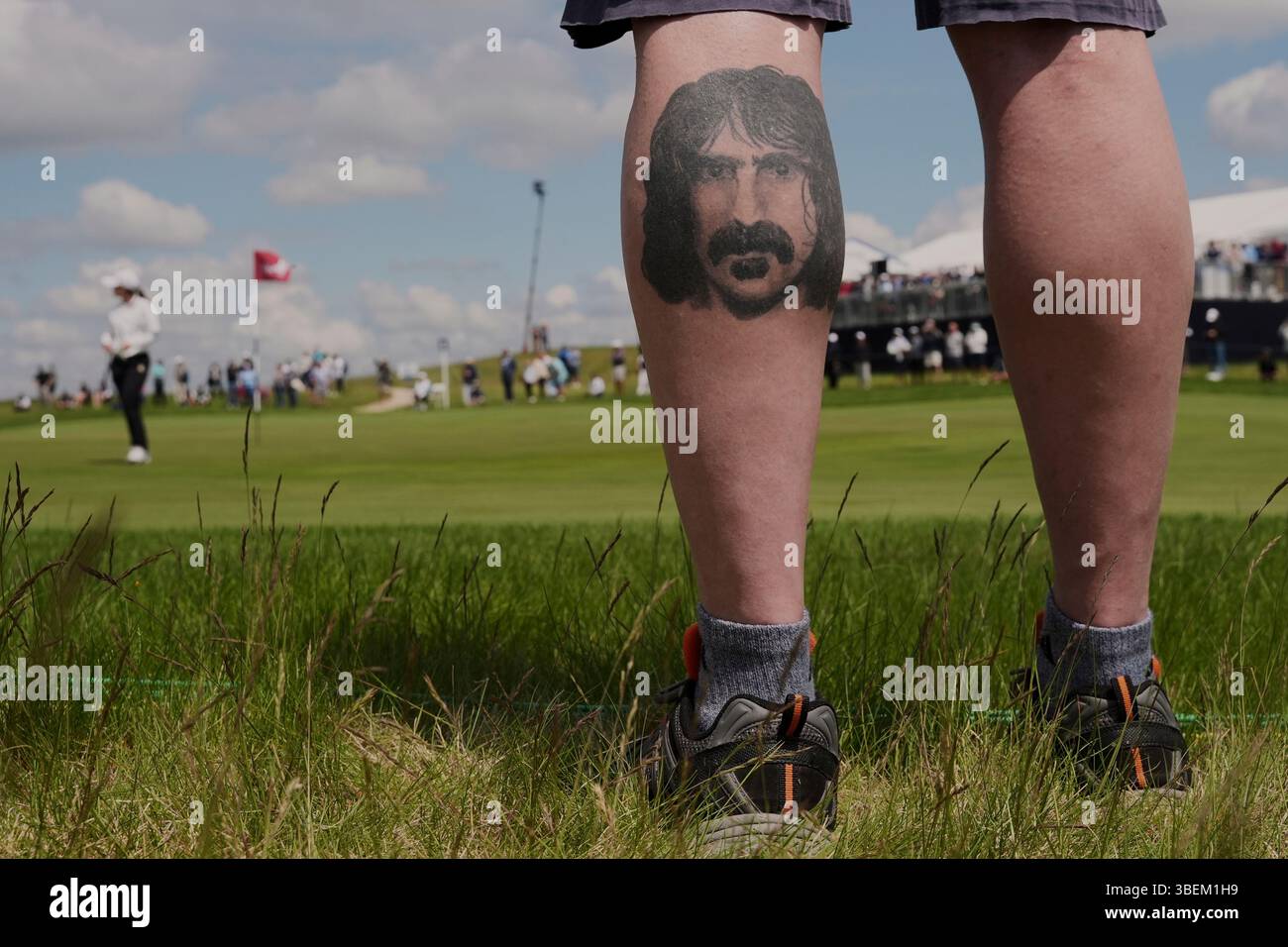 A fan shows off a tattoo of Frank Zappa at the sixth hole during the ...