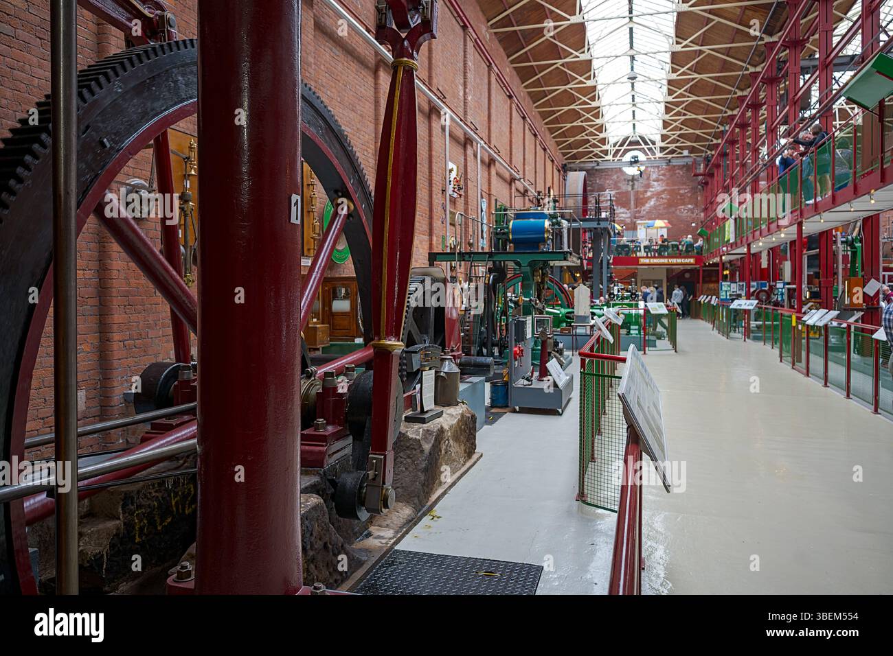 Industrial steam engine machinery exhibit in a spacious vintage factory ...