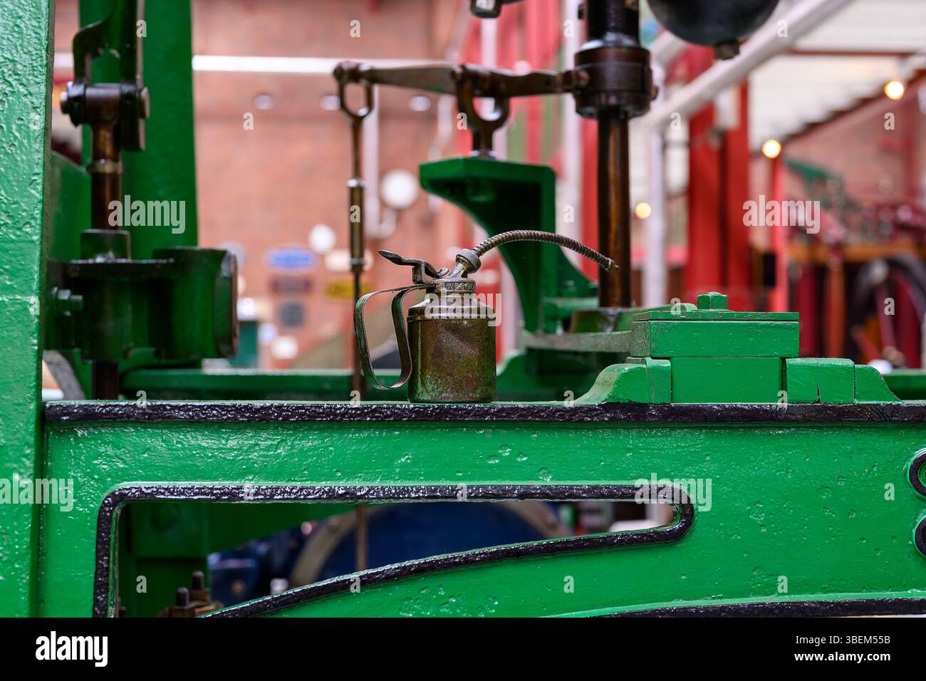Vintage machinery with an oil can on a green industrial steam engine ...