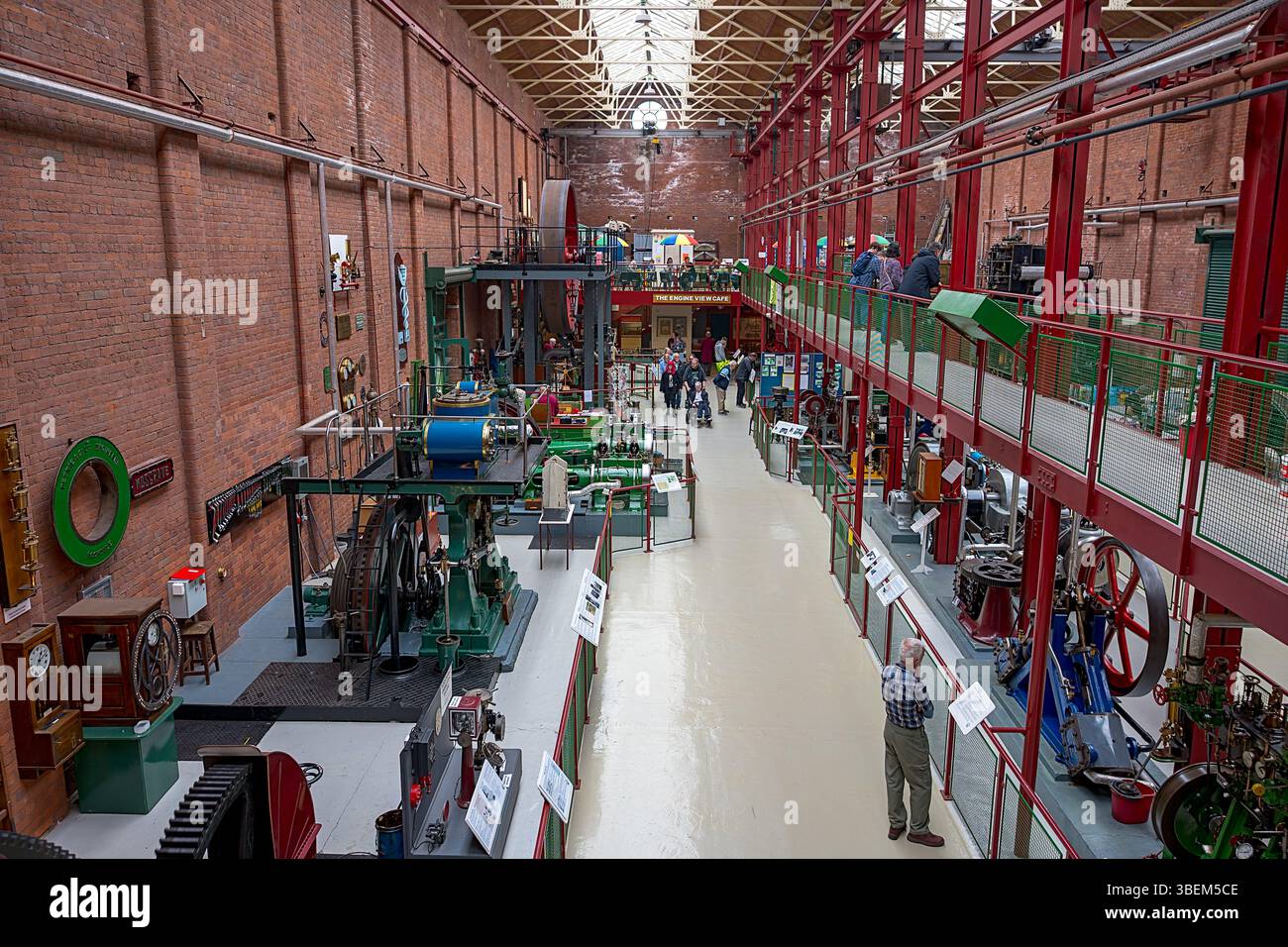Industrial steam engine museum interior with visitors exploring vintage ...