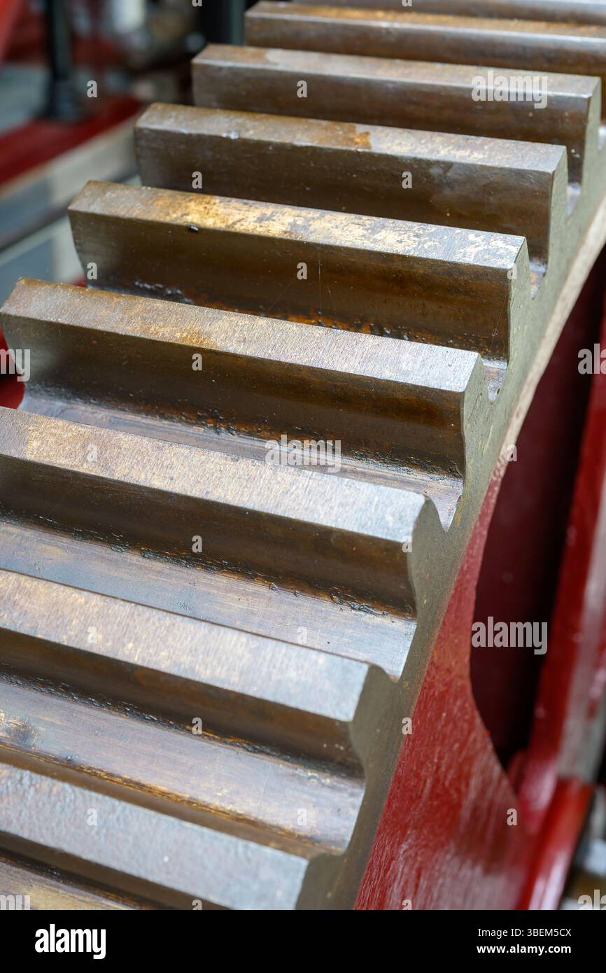Close-up of a large metal geared wheel in a steam powered industrial ...