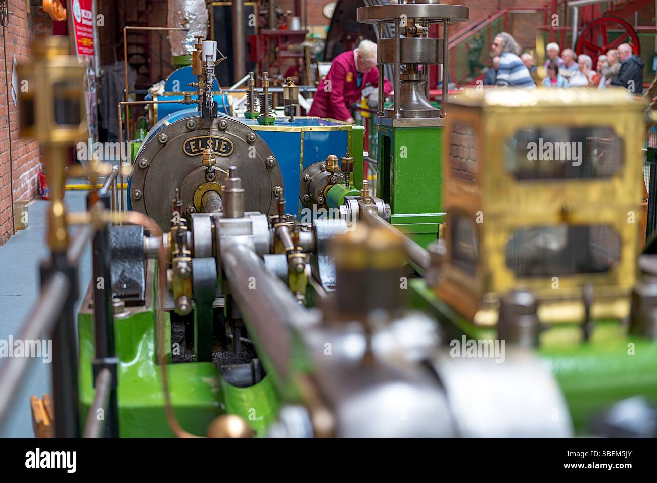 Vintage steam powered engine display with green and brass machinery ...