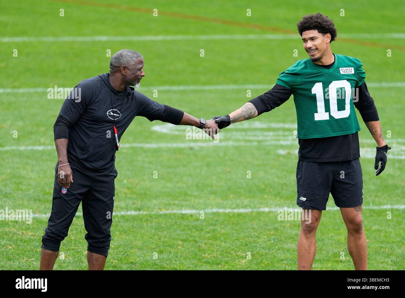 New York Jets' Allen Lazard, right, greets head coach Aaron Glenn ...