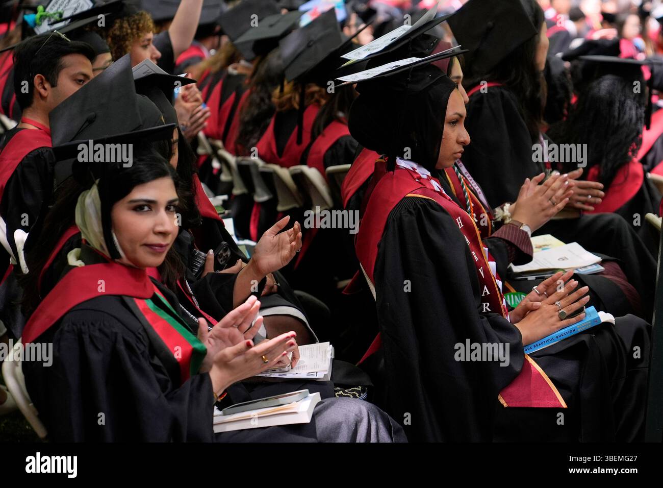 Graduating students applaud during commencement ceremonies at Harvard ...