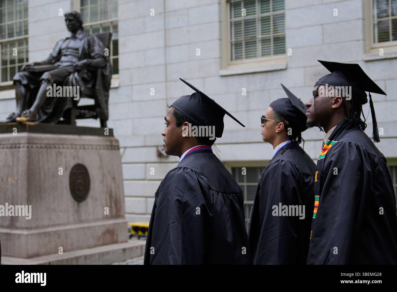 Graduating students walk through Harvard Yard during commencement ...