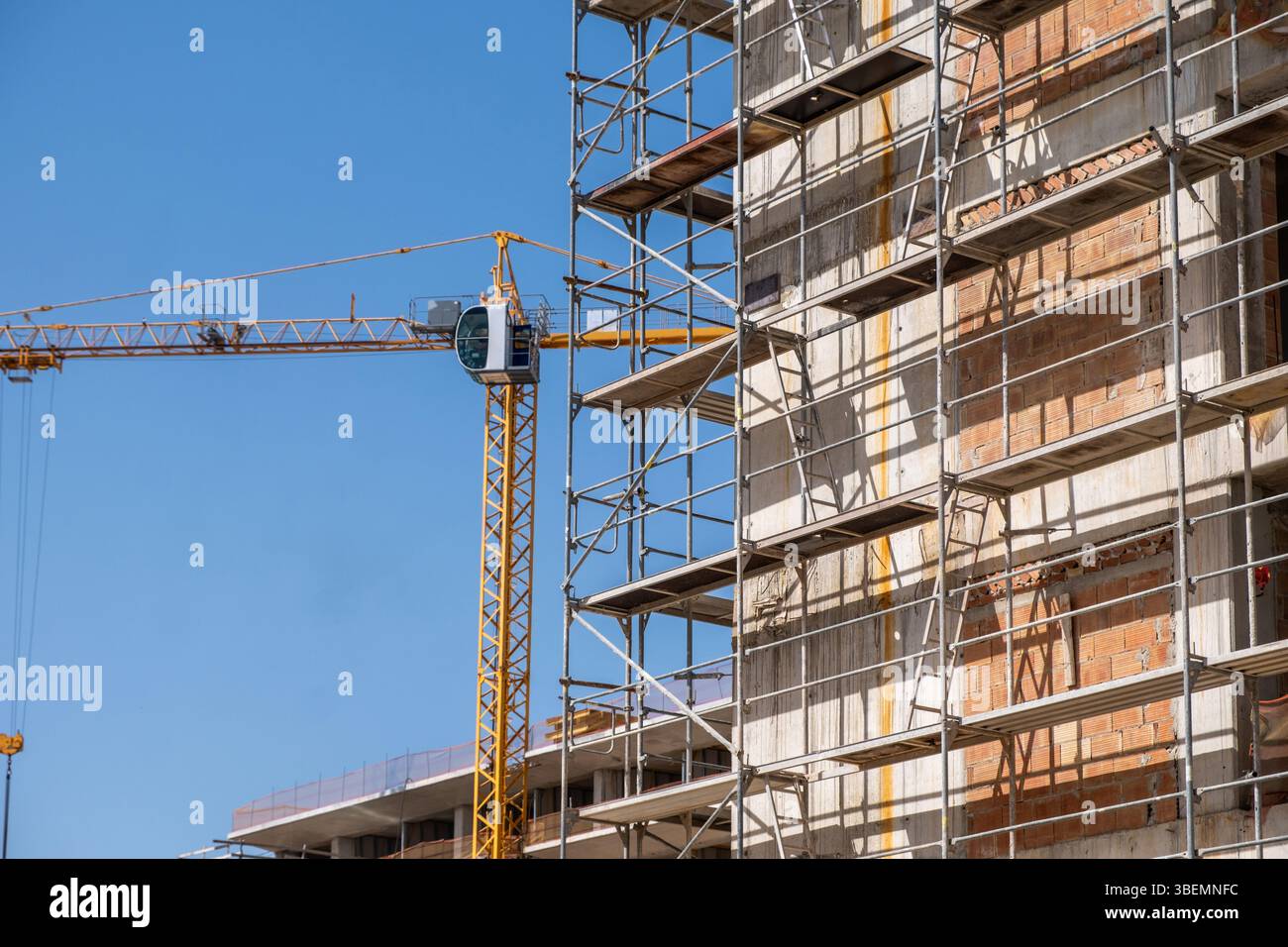 Building construction site, scaffolding system and tower crane, under construction project, blue ...