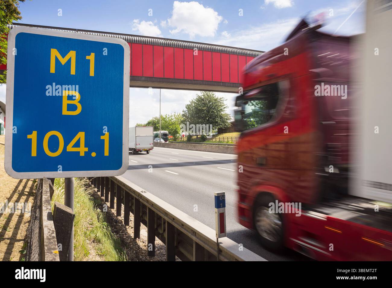 A heavy goods vehicle passes a Driver Location Sign alongside the M1 ...