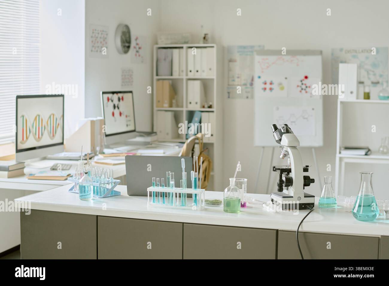Well-lit science laboratory with computers, glassware, microscopes, and ...