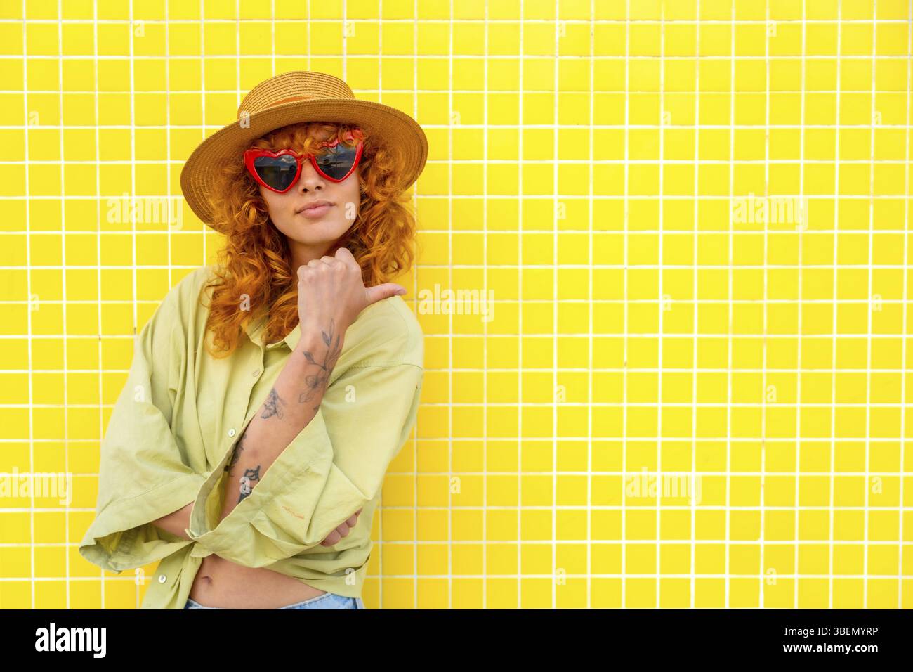 Fashionable influencer posing confidently against a vibrant yellow ...